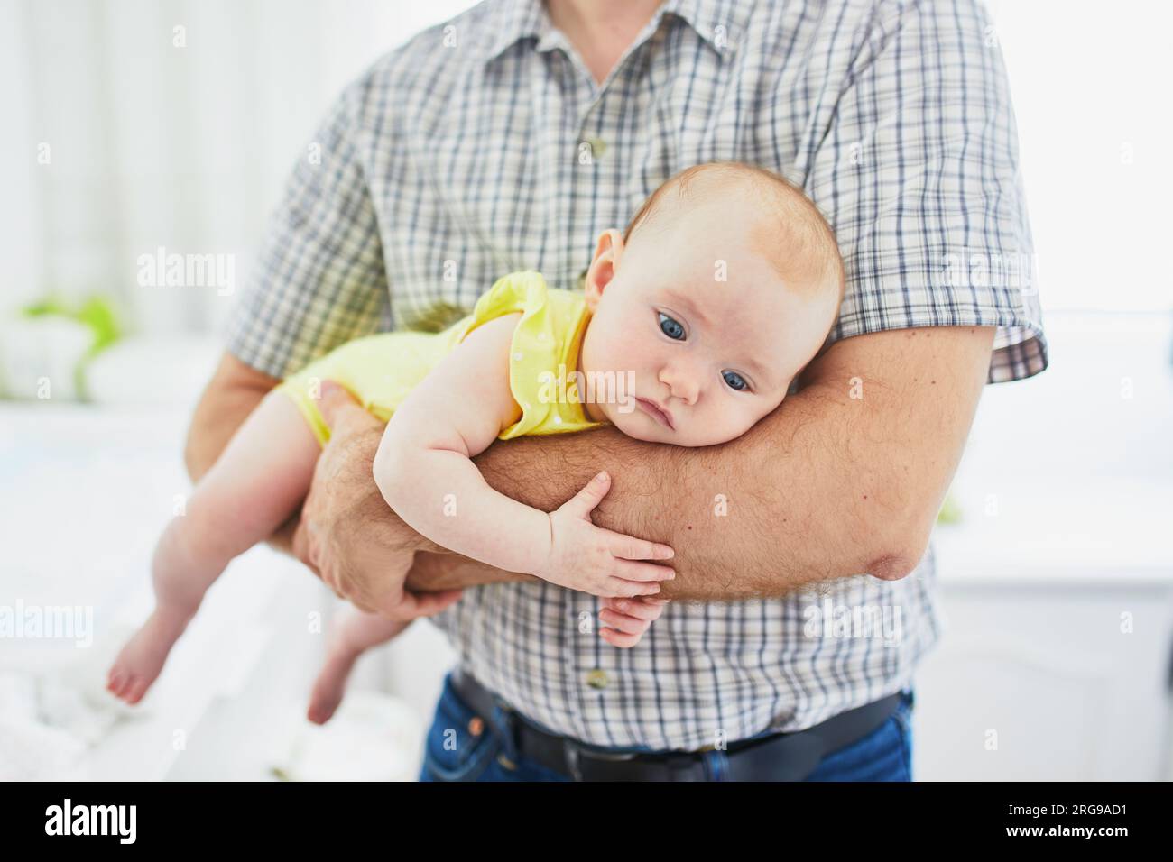 4 months adorable baby girl lying on tummy in her father's hands Stock ...