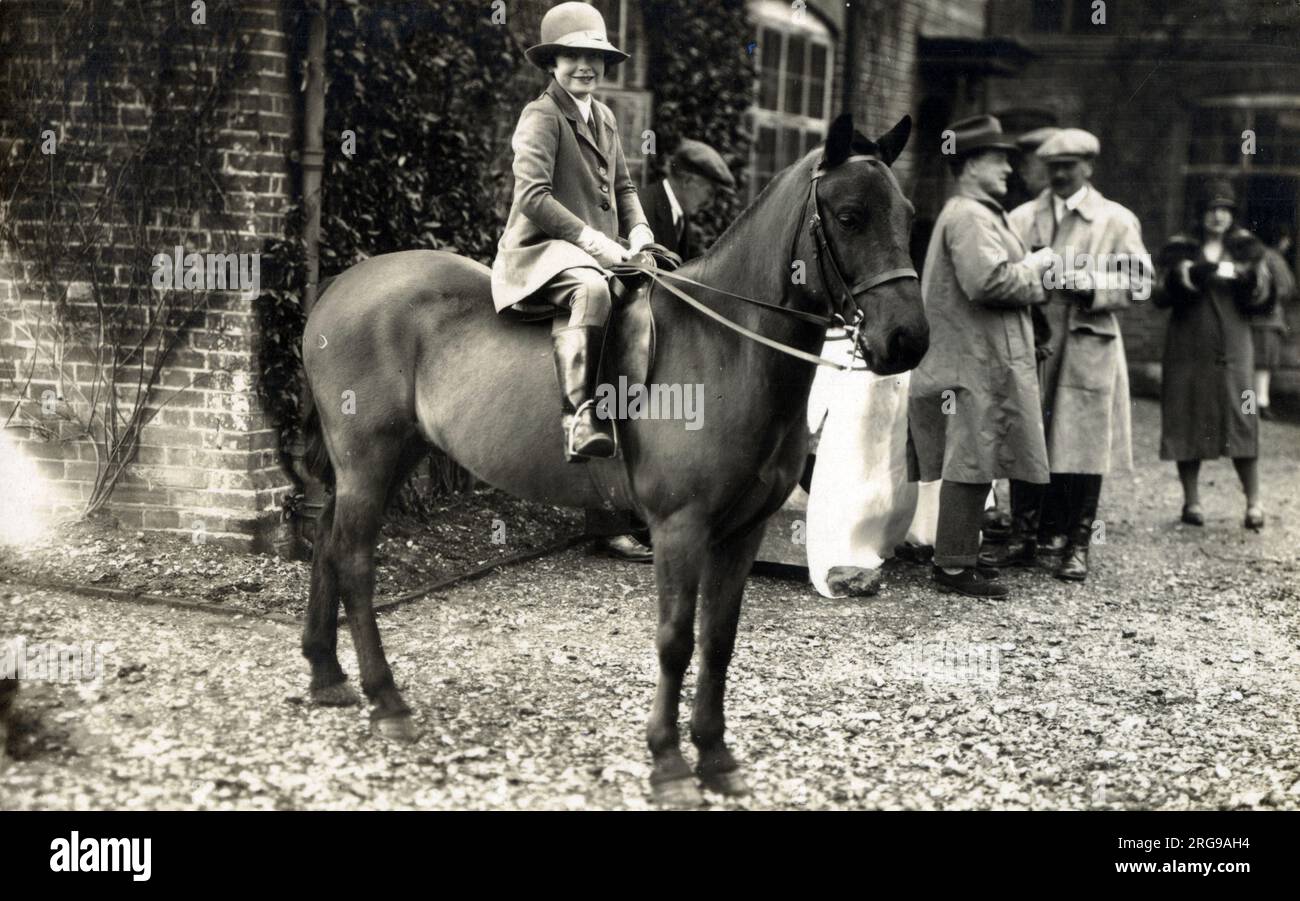 Young girl proudly riding her lovely pony at an outdoor country event ...
