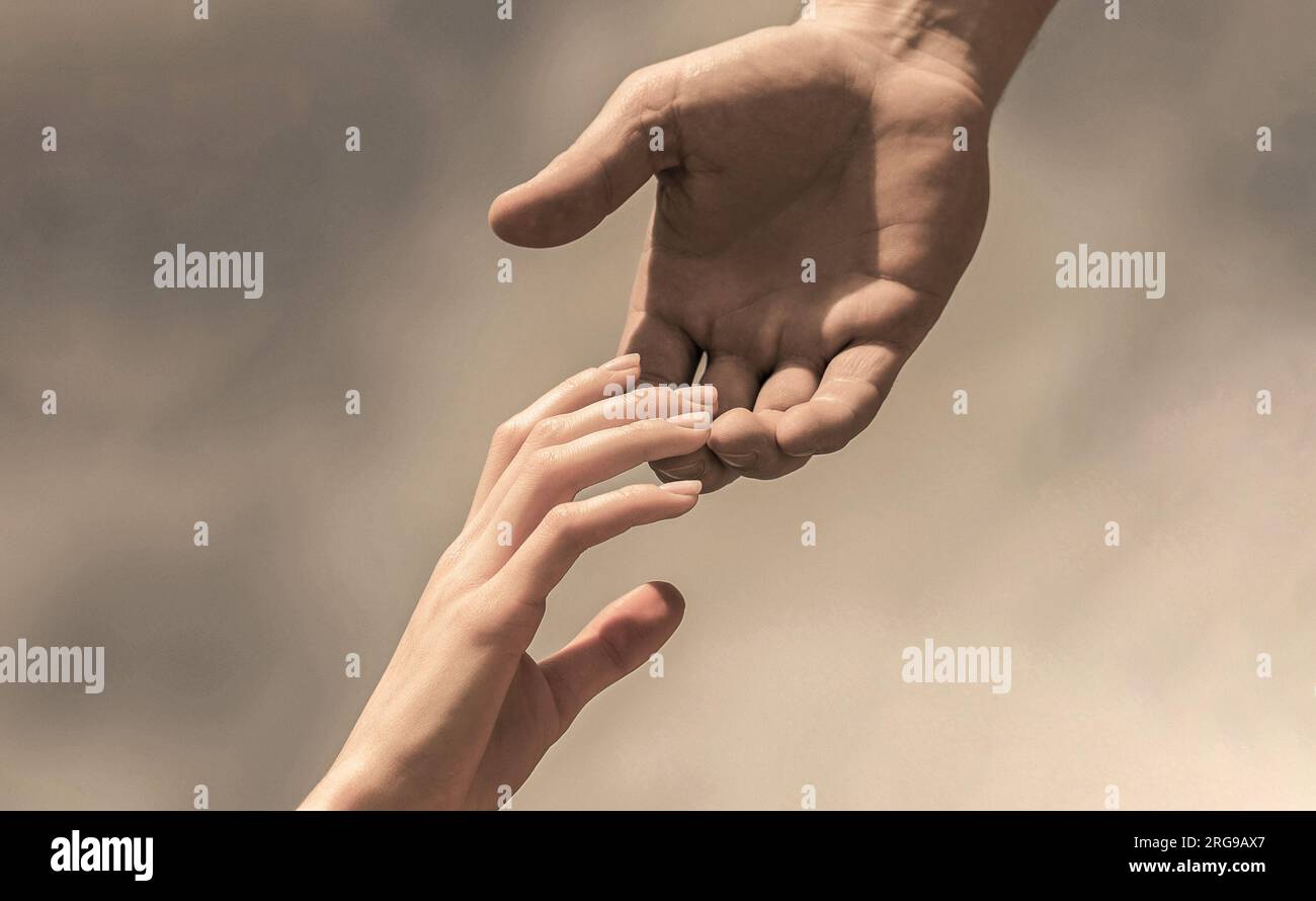 Lending a helping hand. Hands of man and woman reaching to each other ...