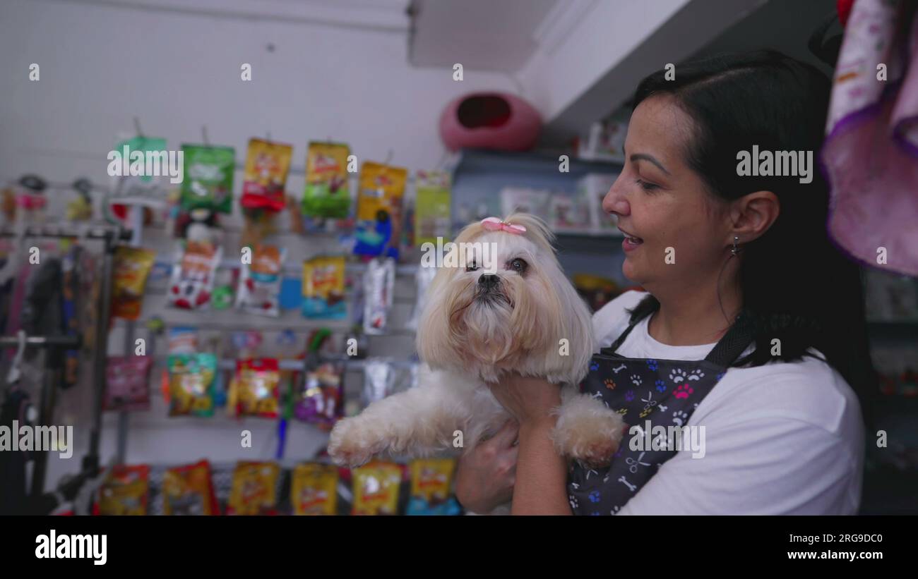 Happy Pet Shop female owner giving Dog back to client after grooming ...