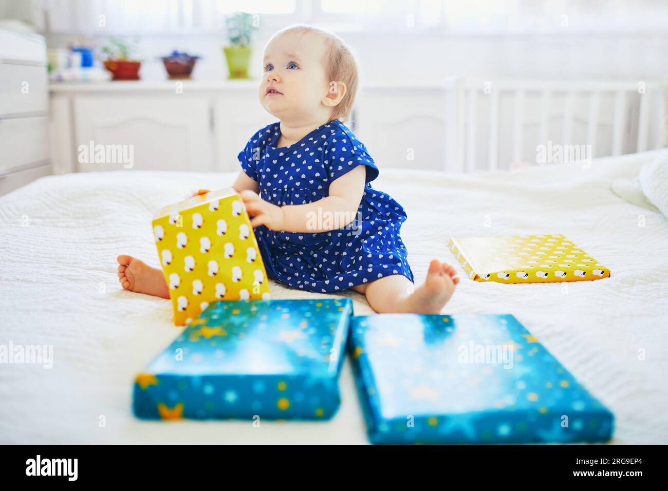 Happy baby girl in blue dress celebrating her first birthday and ...