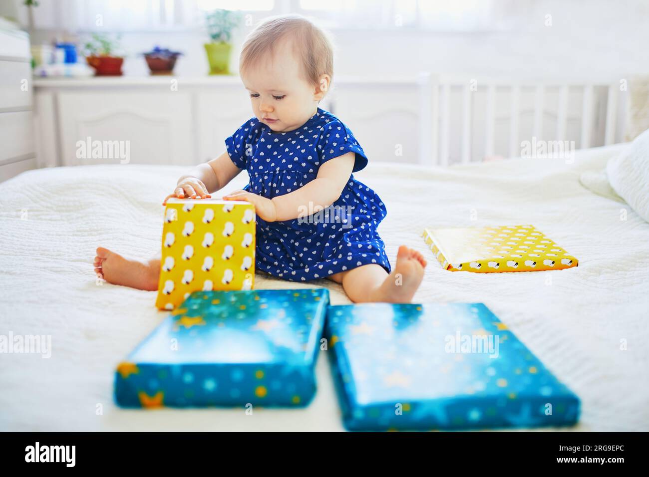 Happy baby girl in blue dress celebrating her first birthday and ...