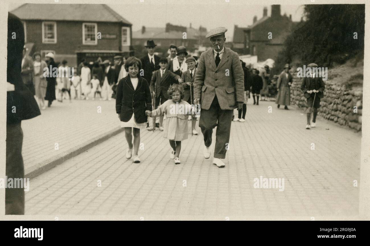 Working class gent walks proudly along a British seaside seafront with ...