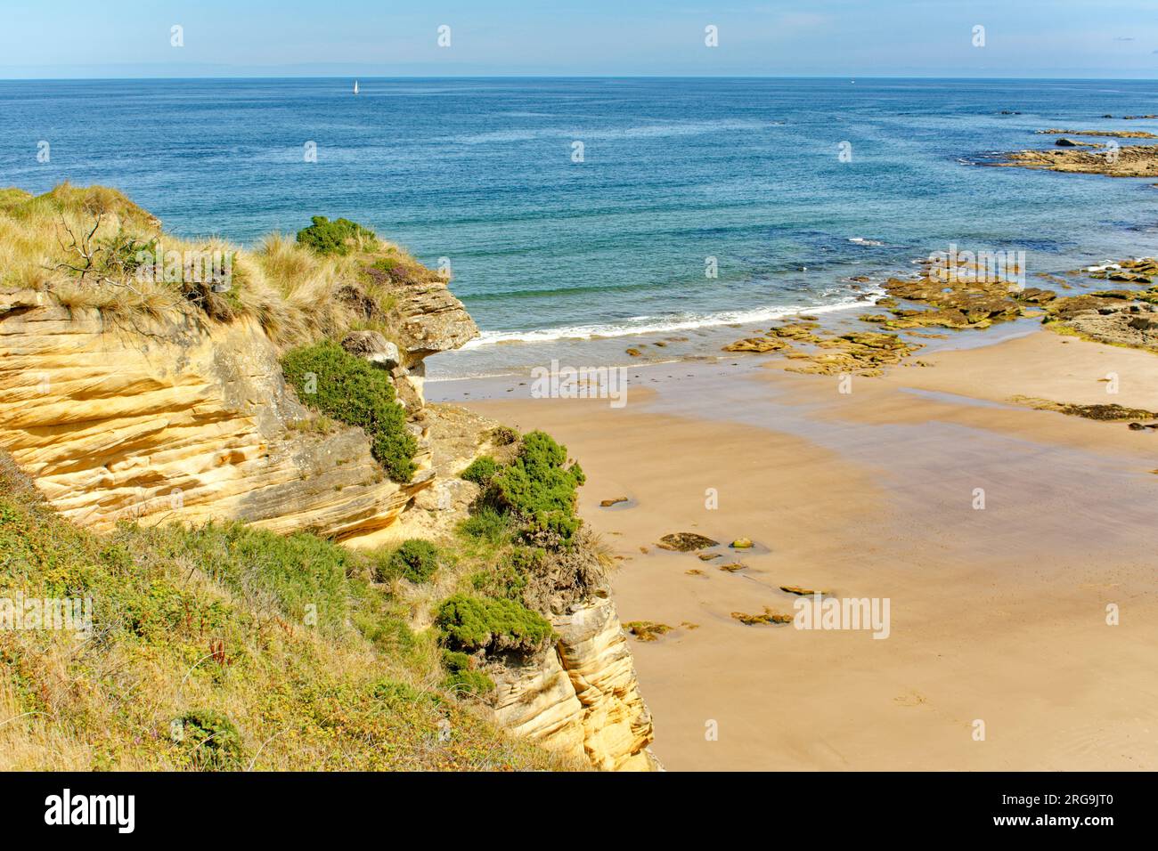 Hopeman Moray Firth Scotland yellow sandstone cliff a blue sky a blue ...
