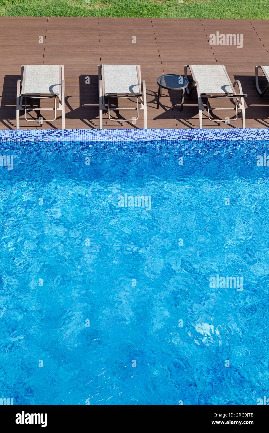 swimming pool with beach lounge chairs Stock Photo - Alamy