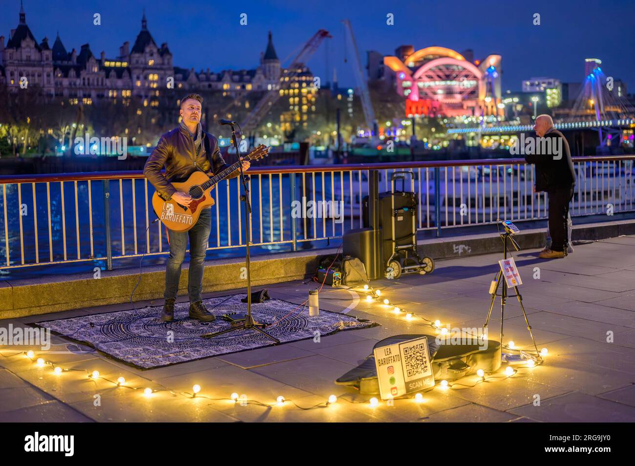 LONDON - April 22, 2023: Enchanting night: Busker entertains tourists ...