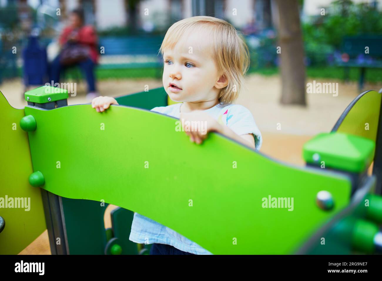 Adorable toddler feeling sad on playground. Outdoor activities for kids ...