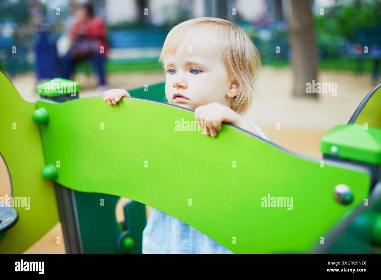 Adorable toddler feeling sad on playground. Outdoor activities for kids ...