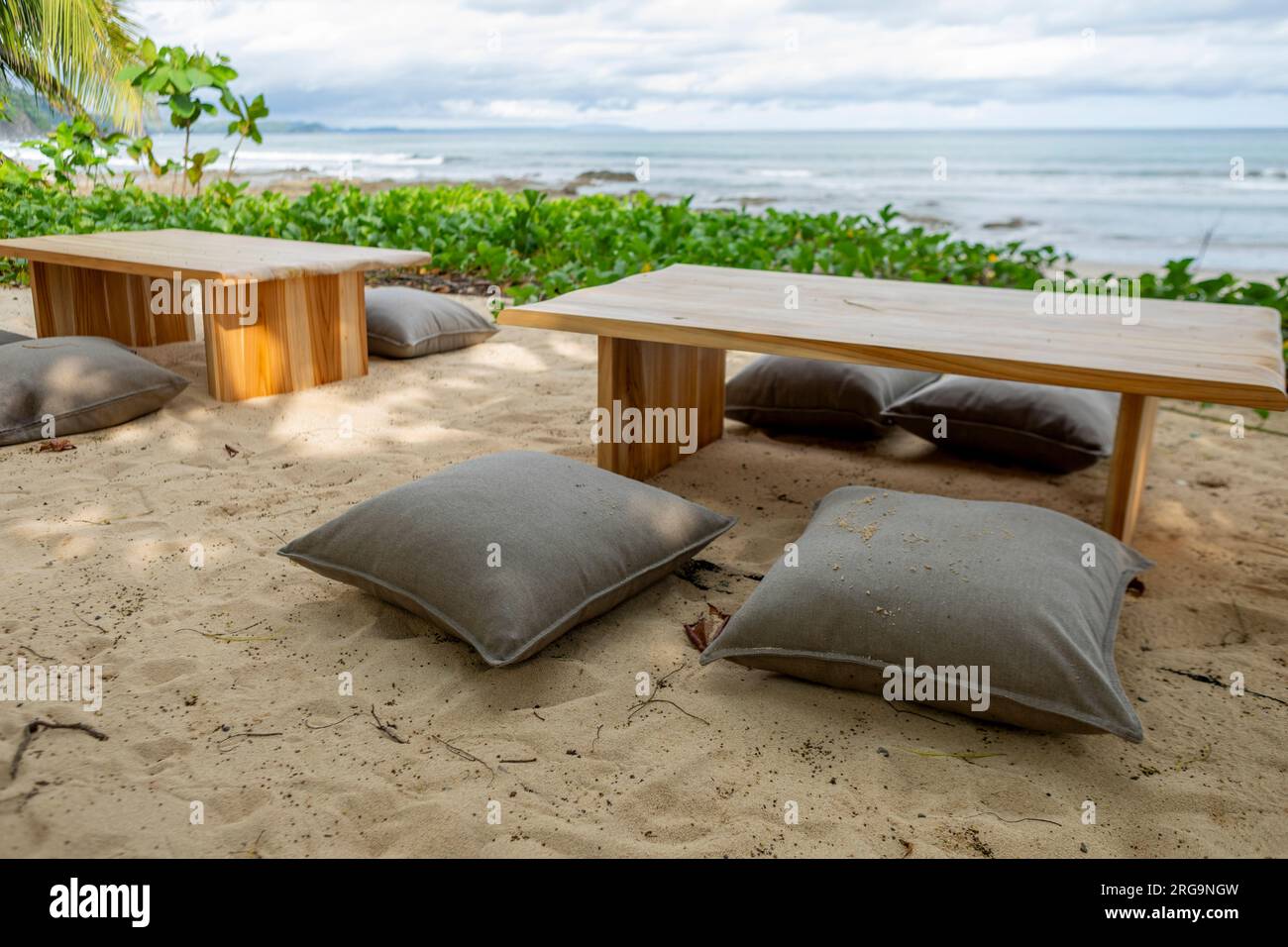 beach table, set over white sand Stock Photo - Alamy
