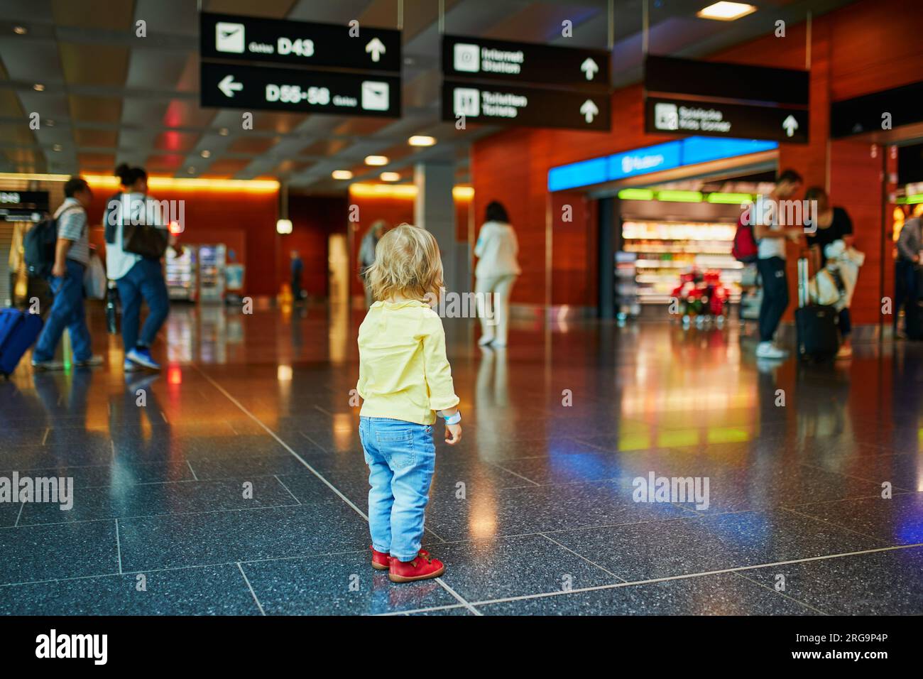 Adorable little girl alone in the airport. Lost toddler looking for ... Adorable little girl alone in the airport. Lost toddler looking for ...