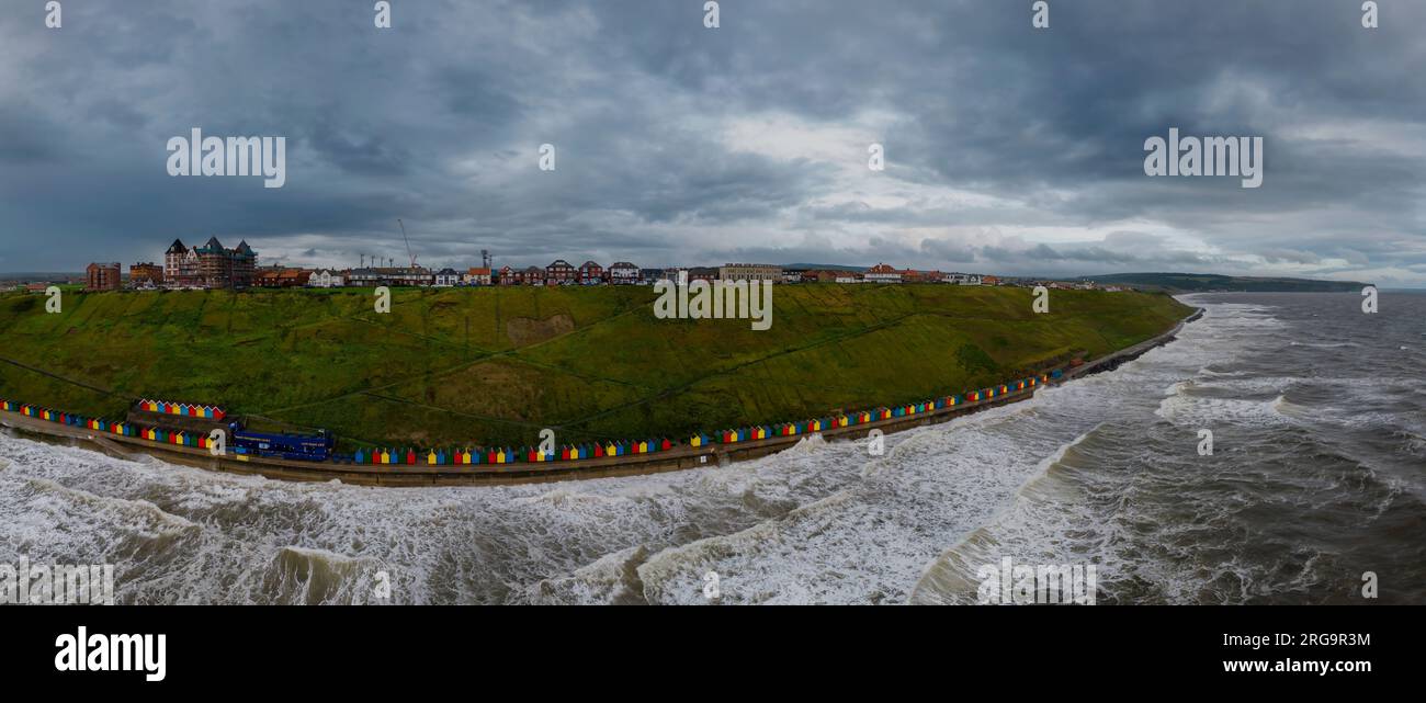 An aerial view of the colourful beach huts along the sea front in ...