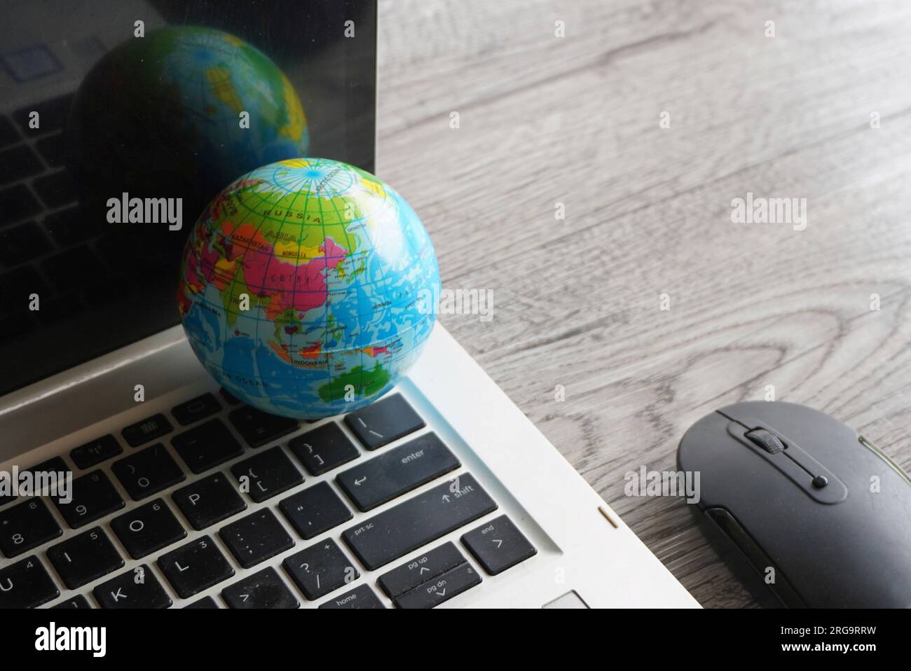 Close up image of globe, laptop keyboard and computer mouse. Internet ...