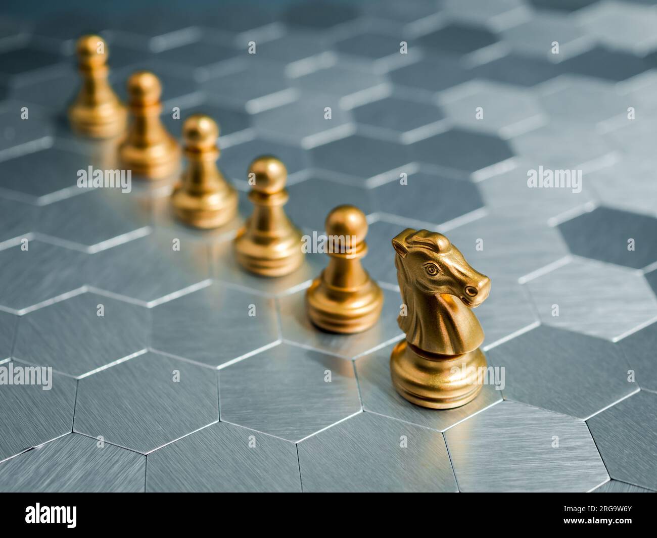 The golden horse, knight chess piece standing front of gold pawn chess ...