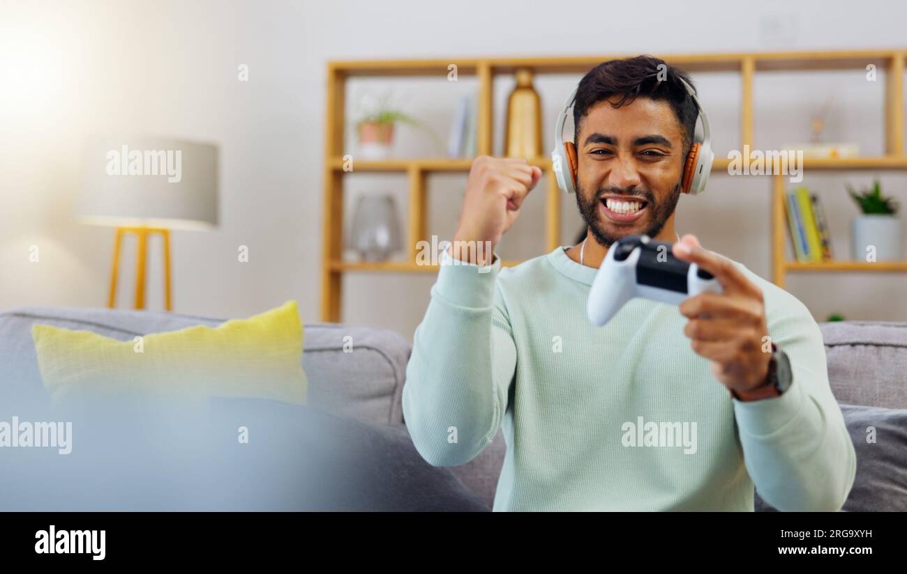 Gaming, winner success and esports with a man in the living room of his ...