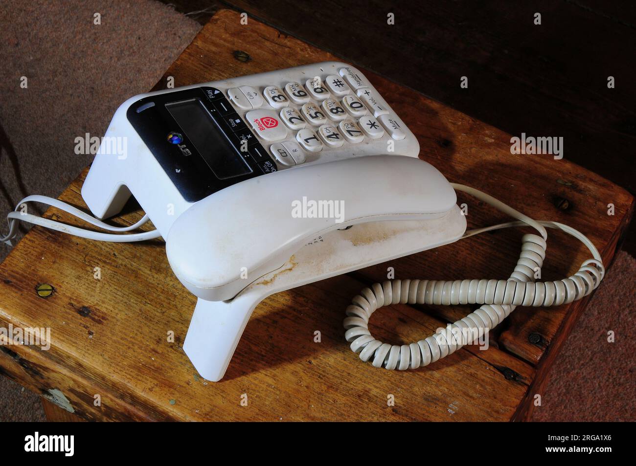 Old fashioned white corded telephone with large numbers Stock Photo - Alamy