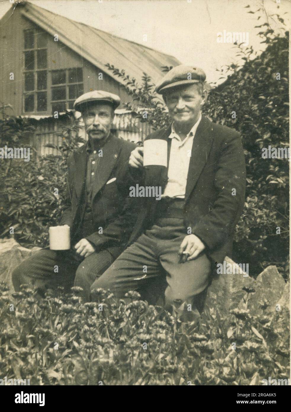 Two working class men enjoying a break from work with a cup of tea ...