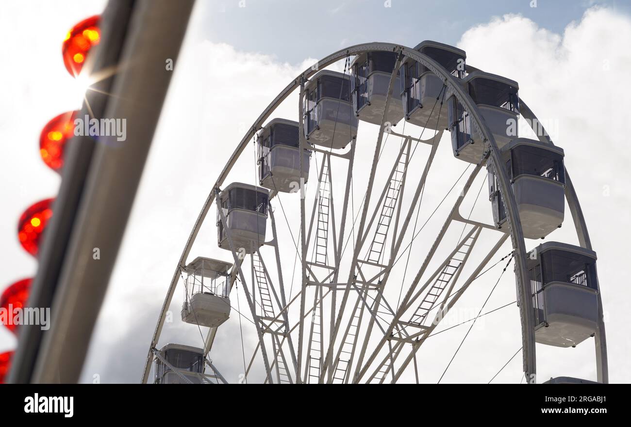 modern ferris wheel with closed cabins at carnival with blue sky no ...