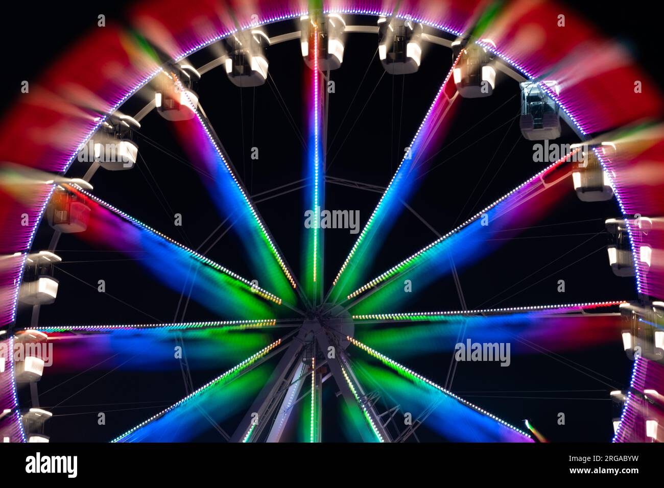 modern ferris wheel with closed cabins at carnival with blue sky no ...