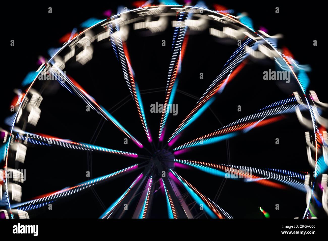 modern ferris wheel with closed cabins at carnival with blue sky no ...