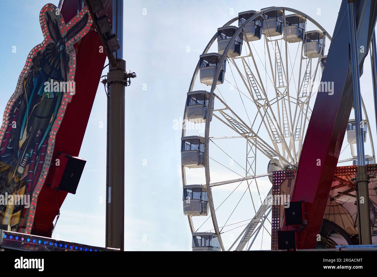 modern ferris wheel with closed cabins at carnival with blue sky no ...