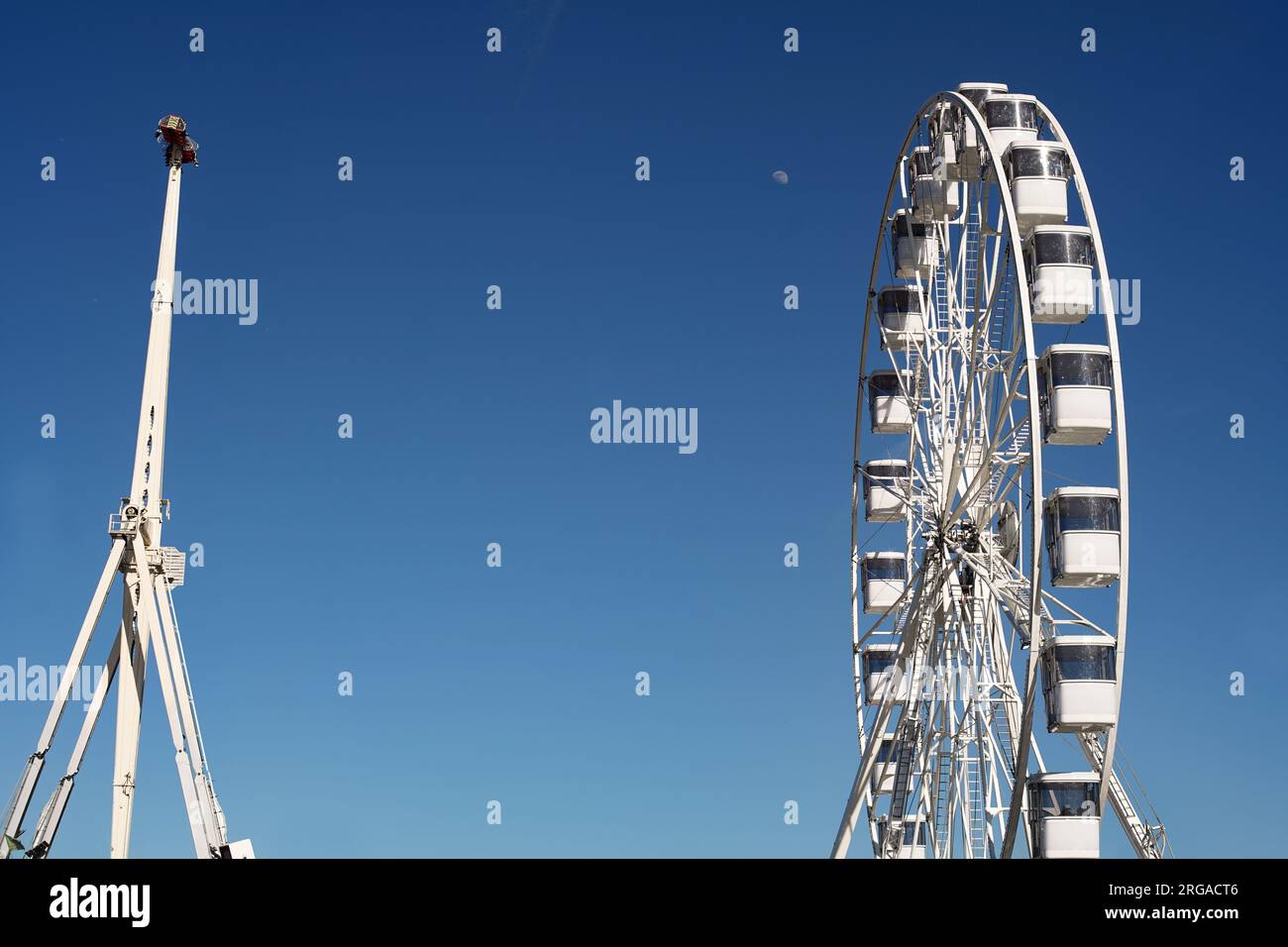 modern ferris wheel with closed cabins at carnival with blue sky no ...