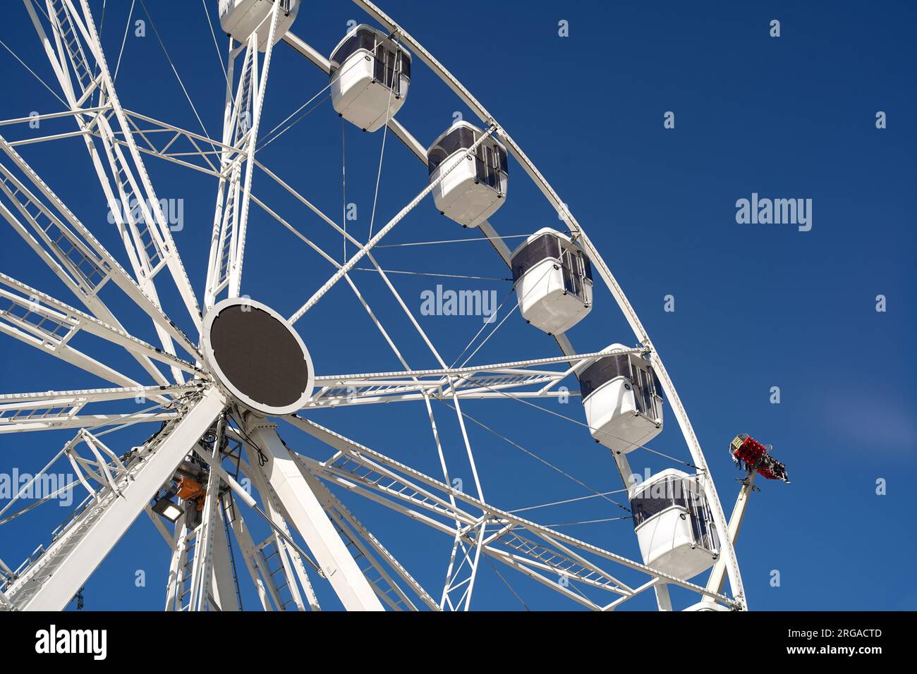 modern ferris wheel with closed cabins at carnival with blue sky no ...