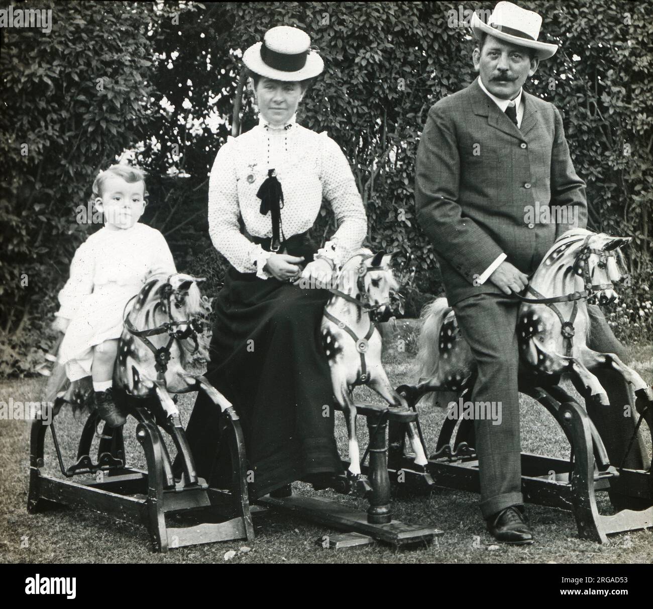 Family on three rocking horses Stock Photo - Alamy