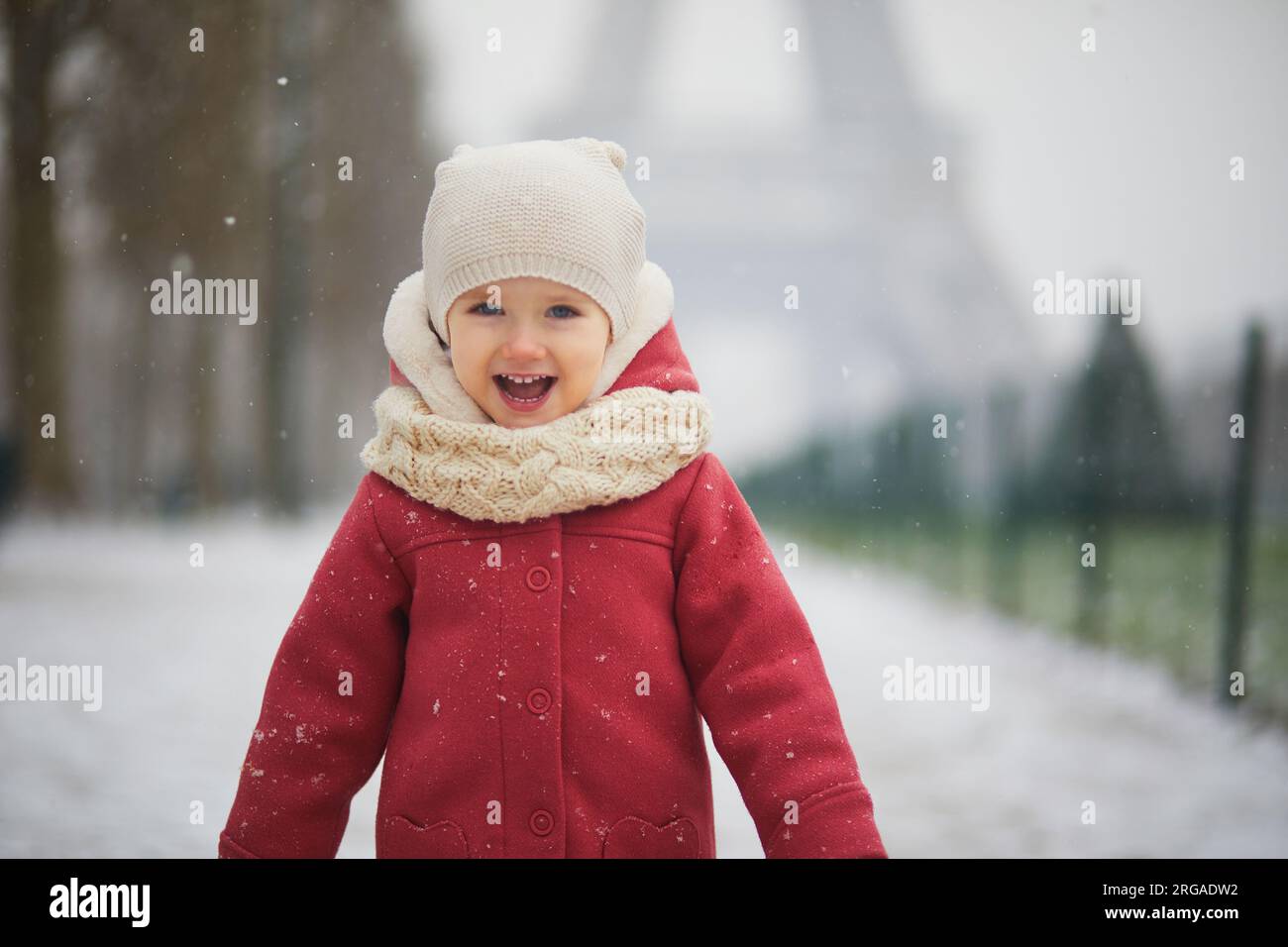 Adorable toddler girl near the Eiffel tower on a day with heavy ...