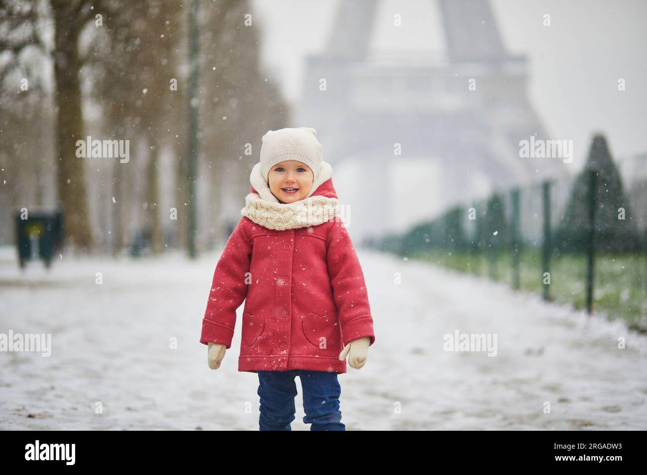 Adorable toddler girl near the Eiffel tower on a day with heavy ...