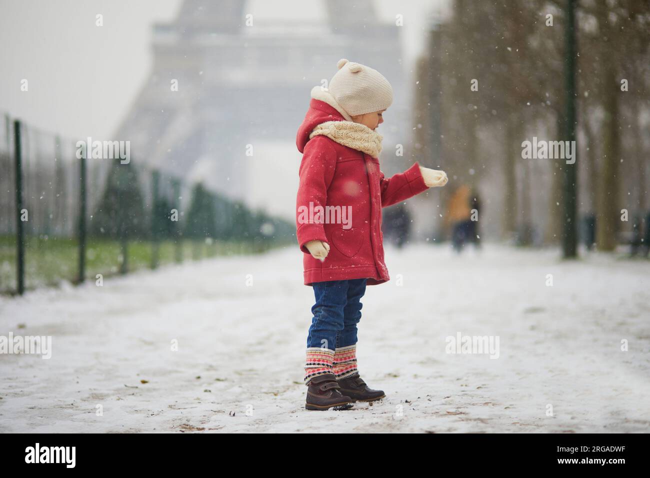 Adorable toddler girl near the Eiffel tower on a day with heavy ...