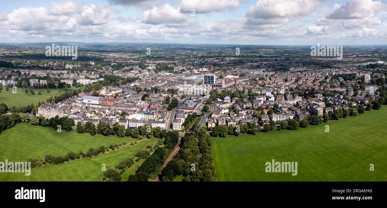 An aerial cityscape of Harrogate town centre with The Stray public park ...