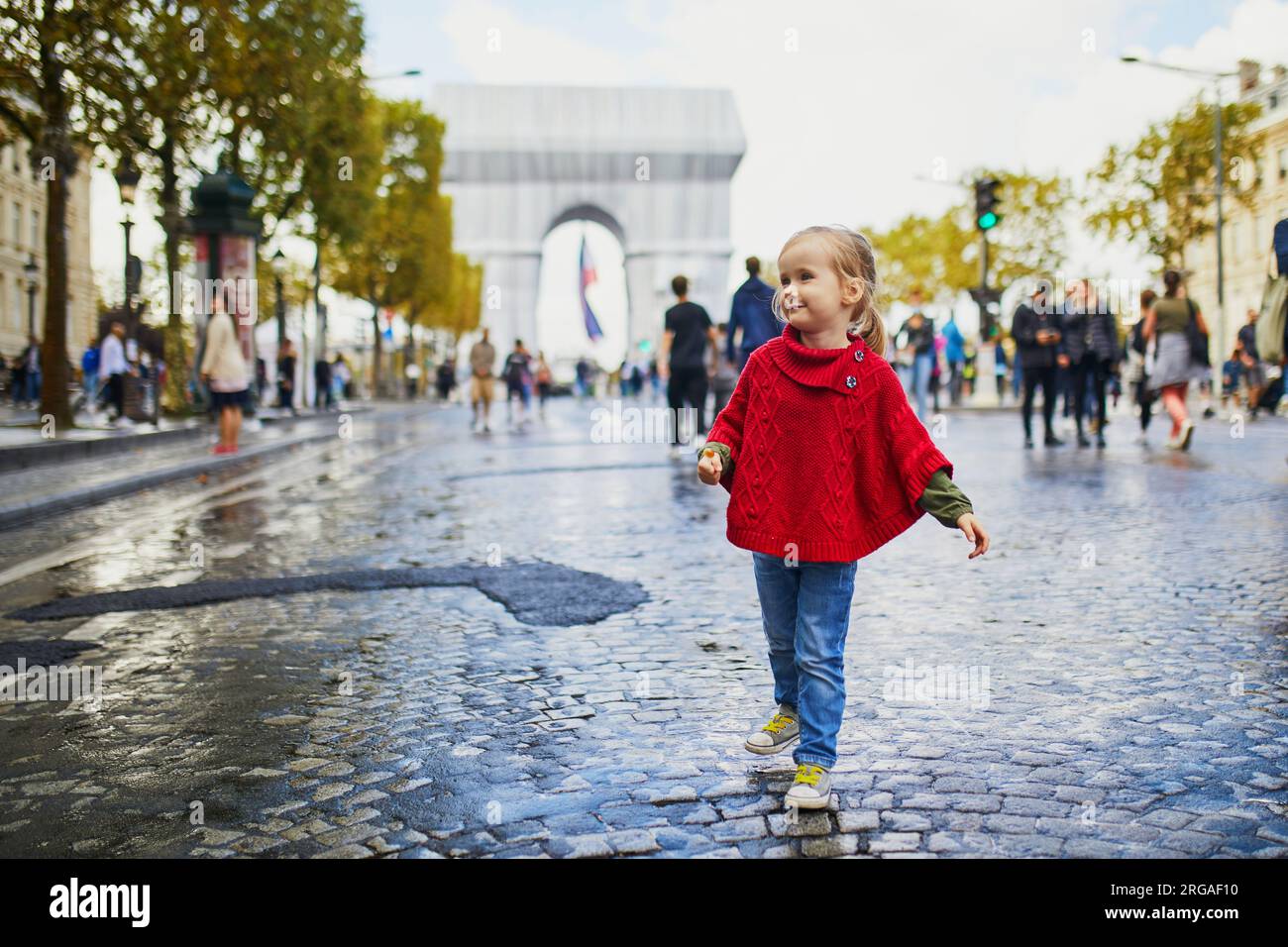 Happy preschooler girl walking in Champs-Elysees in Paris, France ...
