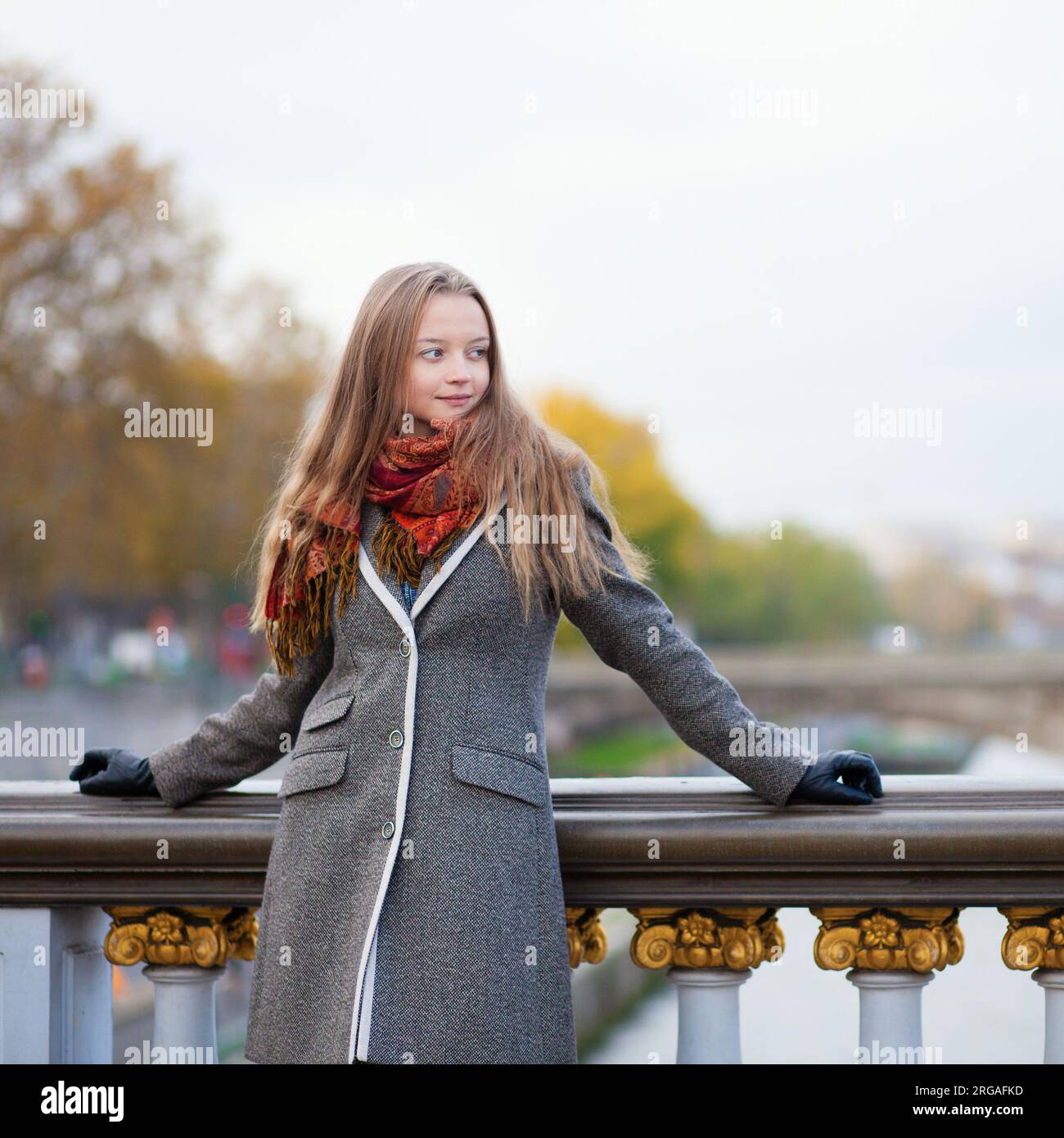 Beautiful young lady in Paris on a bridge Stock Photo - Alamy
