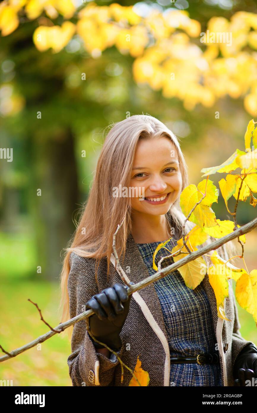 Outdoor autumn portrait of a beautiful young woman Stock Photo - Alamy