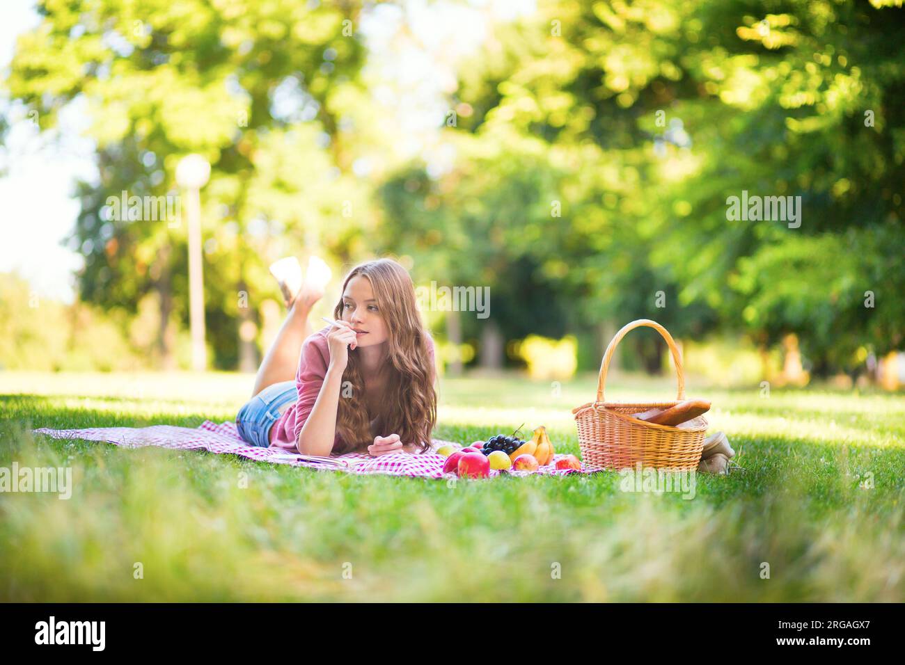 Girl on a picnic in park Stock Photo - Alamy