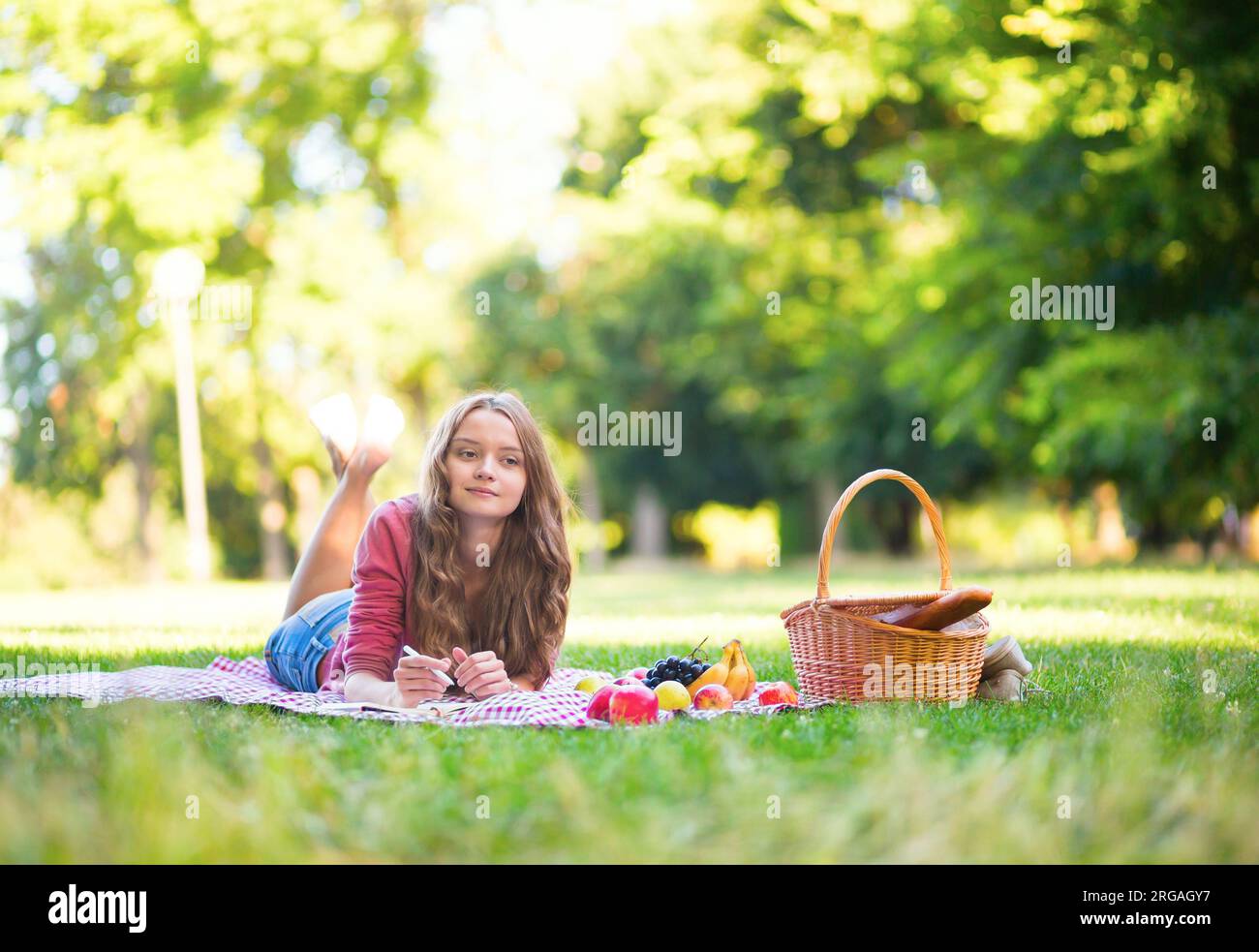 Girl having a picnic in park Stock Photo - Alamy