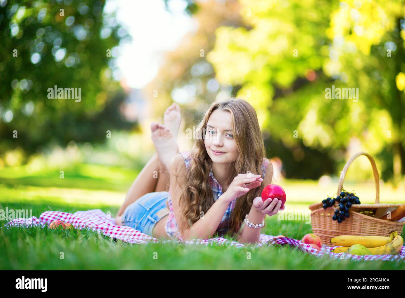 Girl having a picnic in park Stock Photo - Alamy