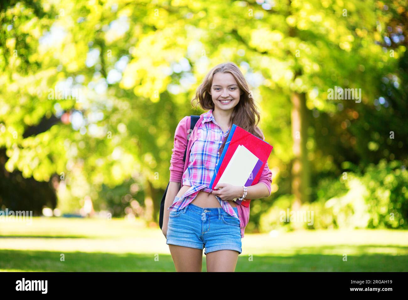 College student with books and folders Stock Photo - Alamy