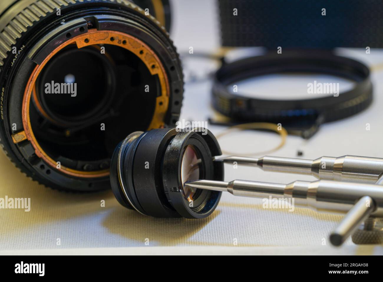 Clean and disassemble the lens for photography into its component parts ...