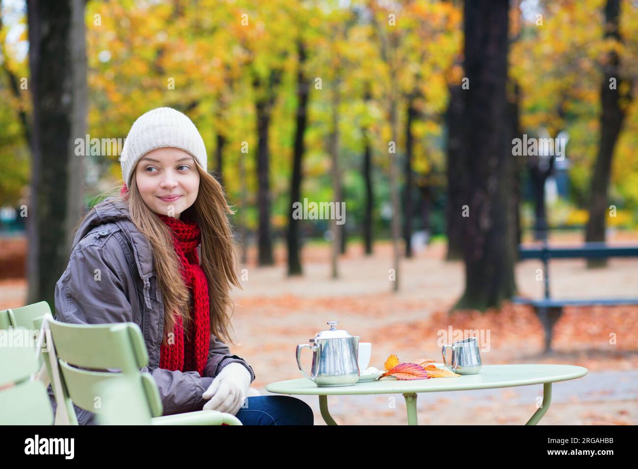 Girl drinking coffee in an outdoor cafe Stock Photo - Alamy
