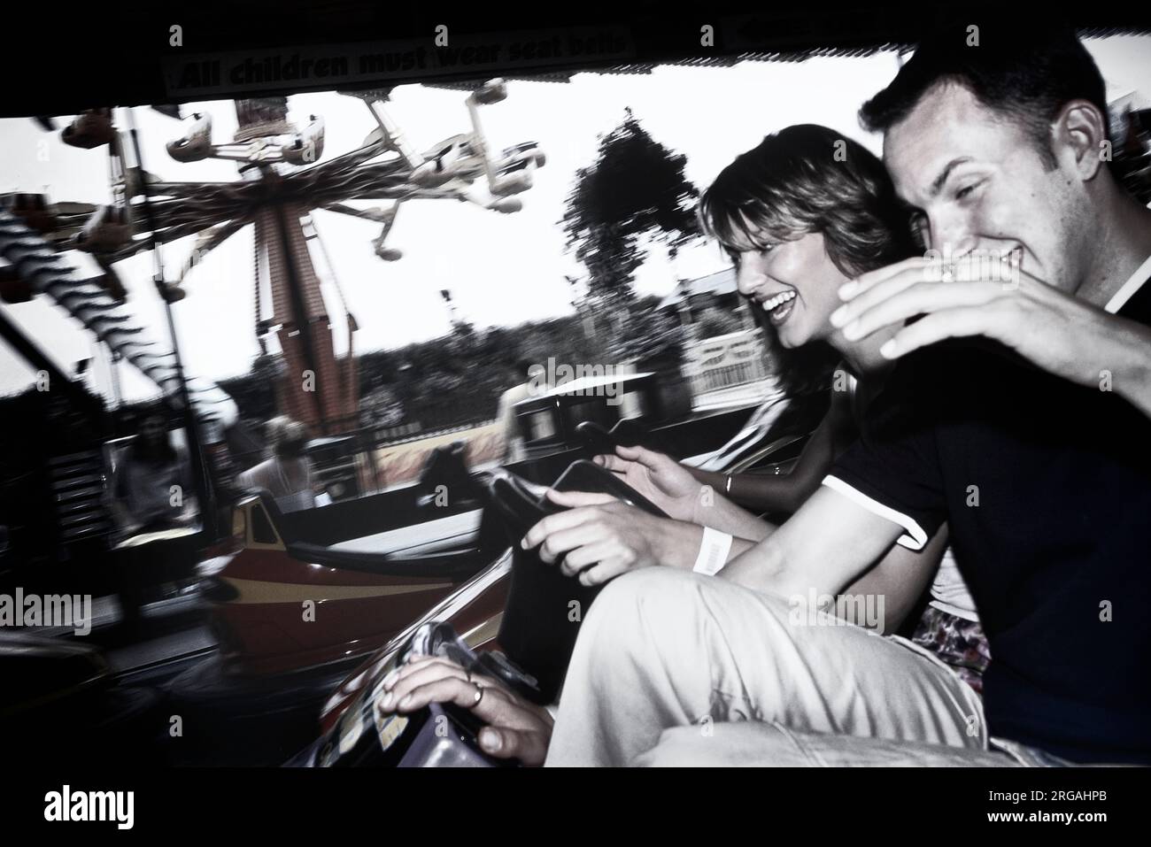 Two young adult passengers on the Bumper cars or Dodgem ride, England ...