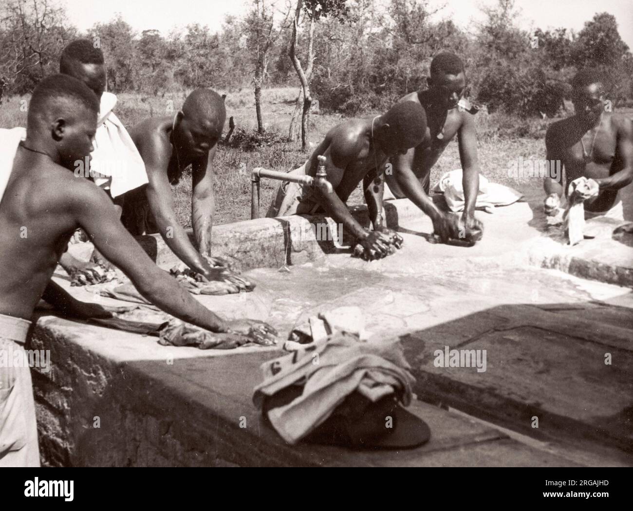 1940s East Africa - askari soldiers washing clothes Photograph by a ...