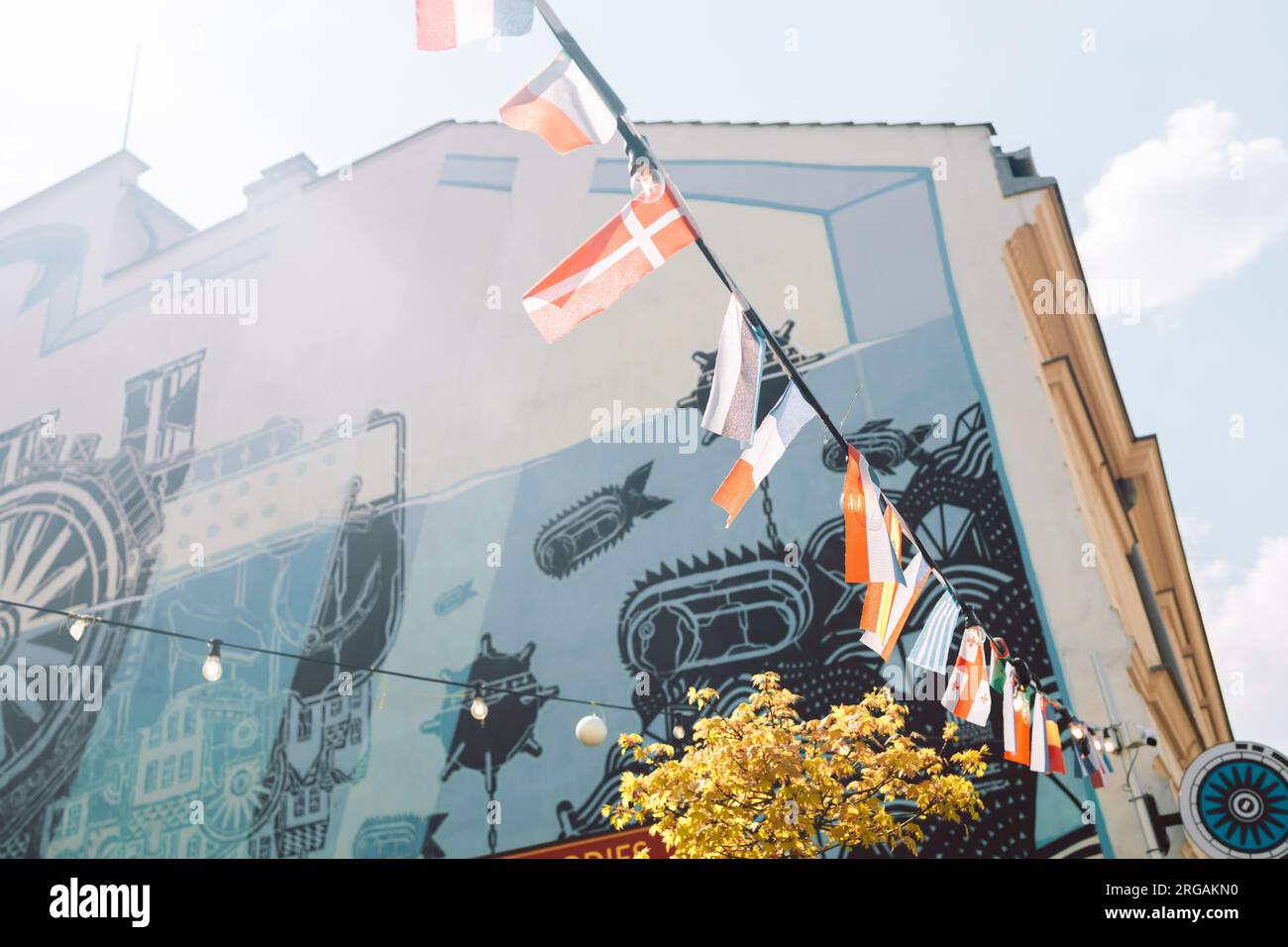 Many countries flags hanging from a ceiling on ropes at summer time ...