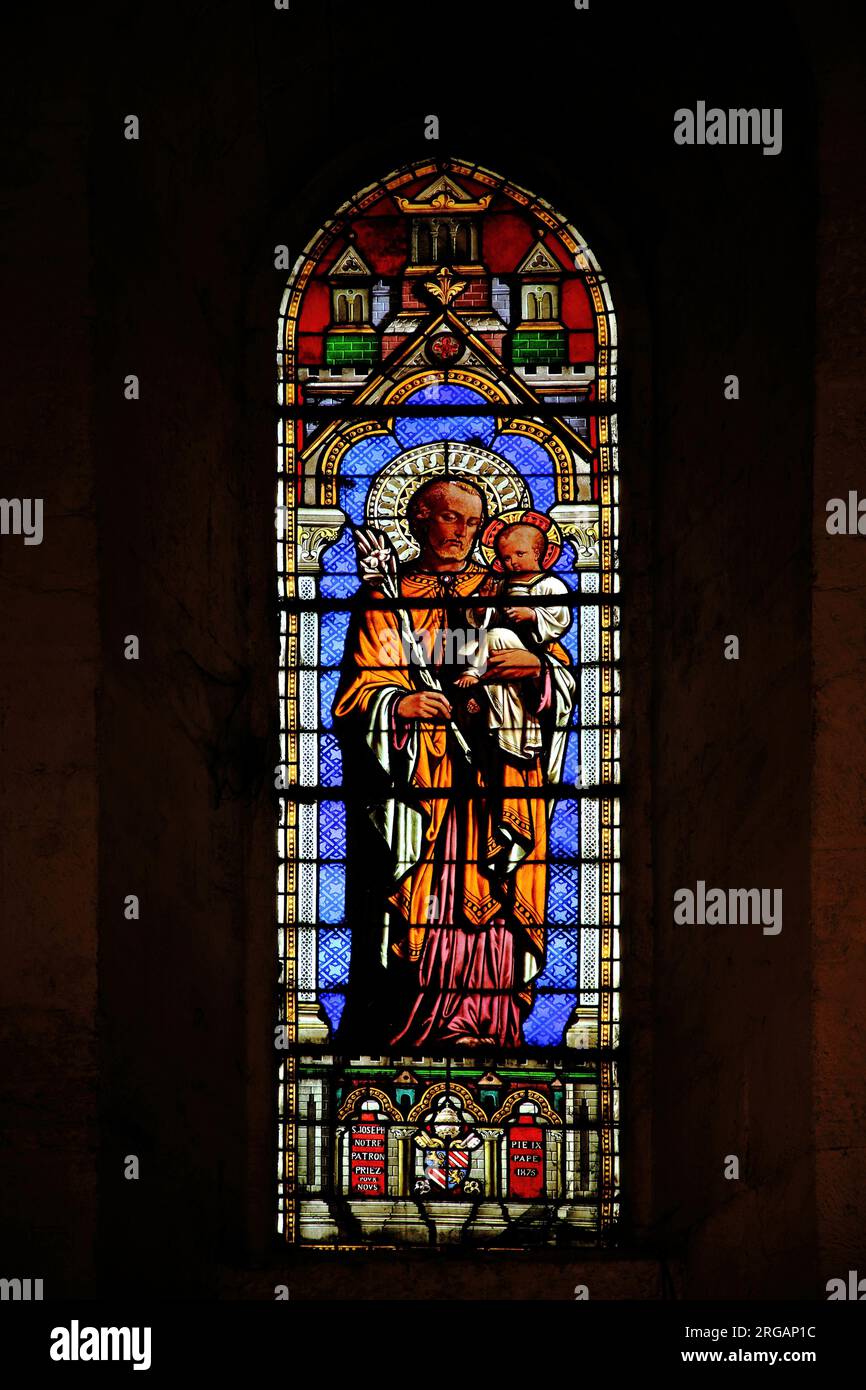 Colorful stained glass window depicting Saint Christopher carrying the ...