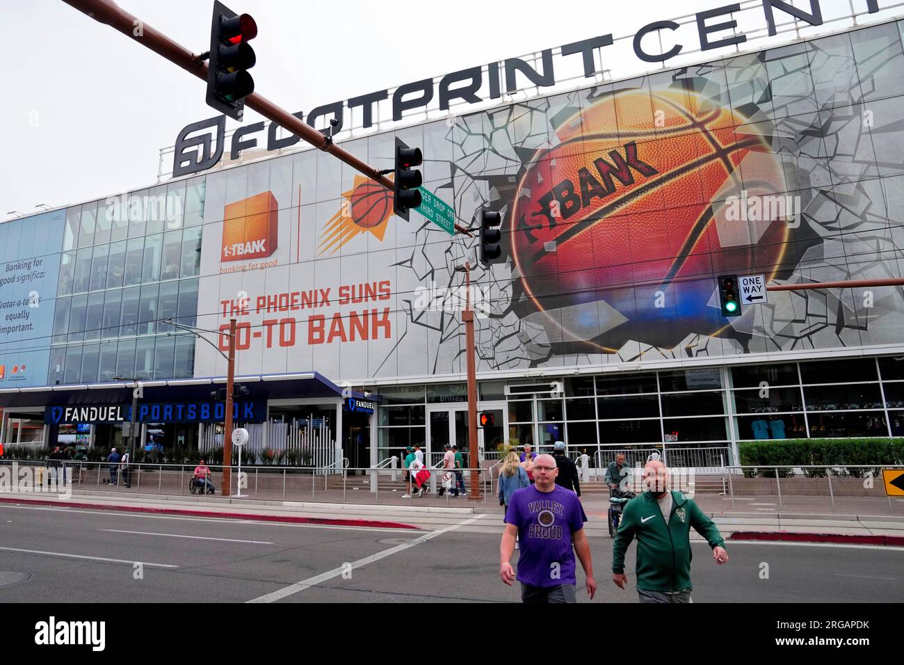 FILE - Fans walks past the Footprint Center, Tuesday, March 14, 2023 ...
