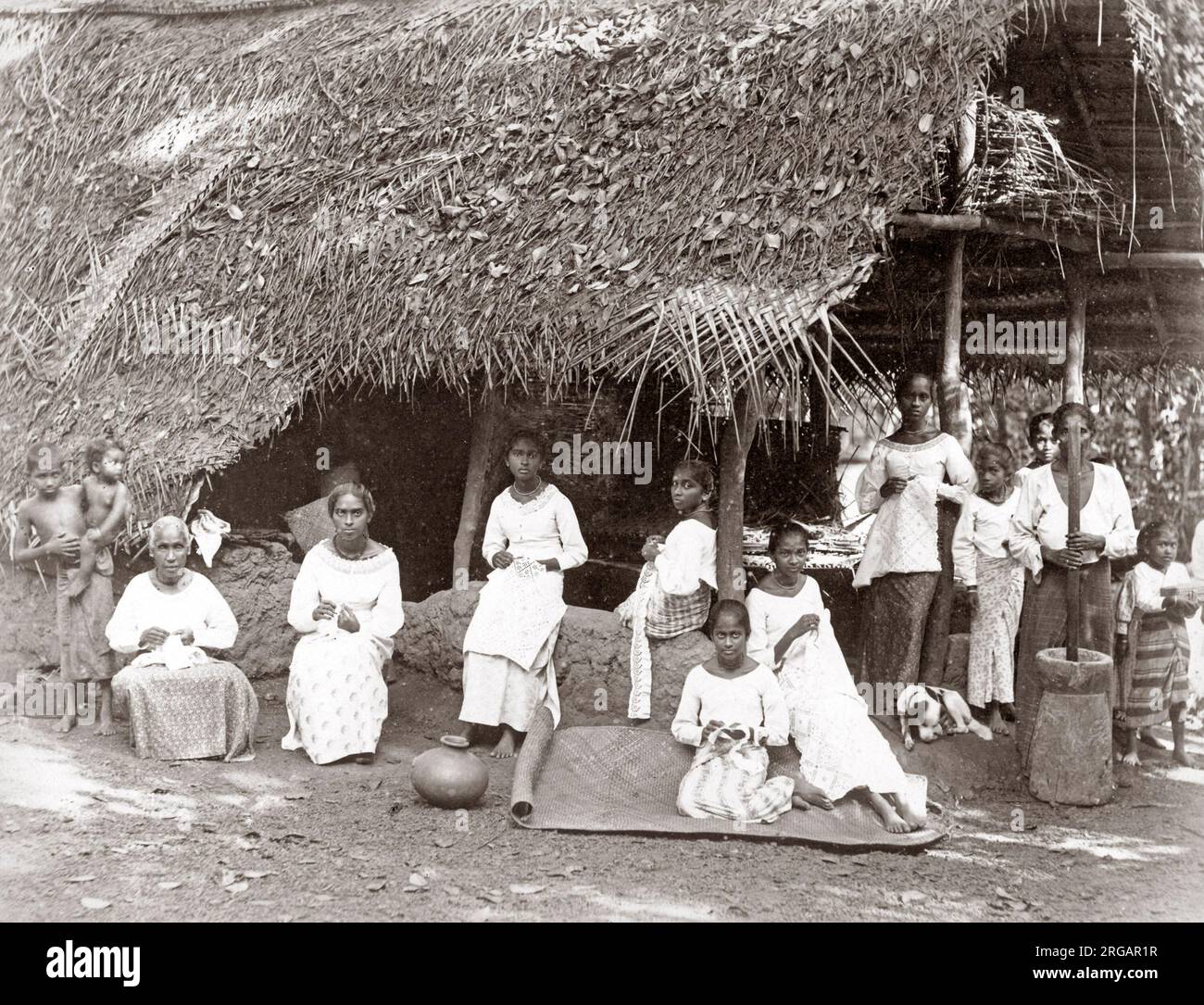 Group of women and children, straw roofed house, India or Ceylon (Sri ...