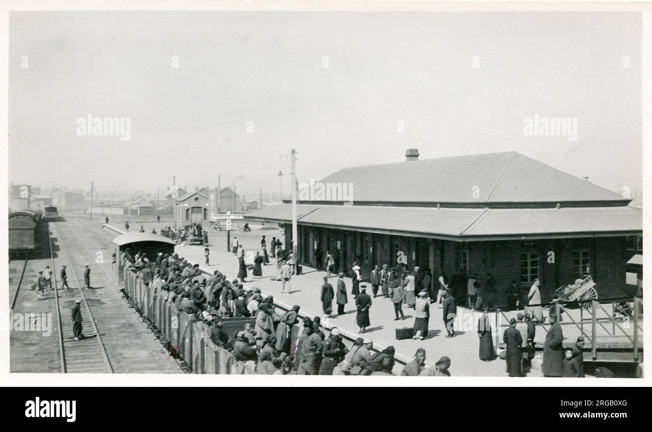 Early 20th century photograph: Railway station, passenger in open train ...