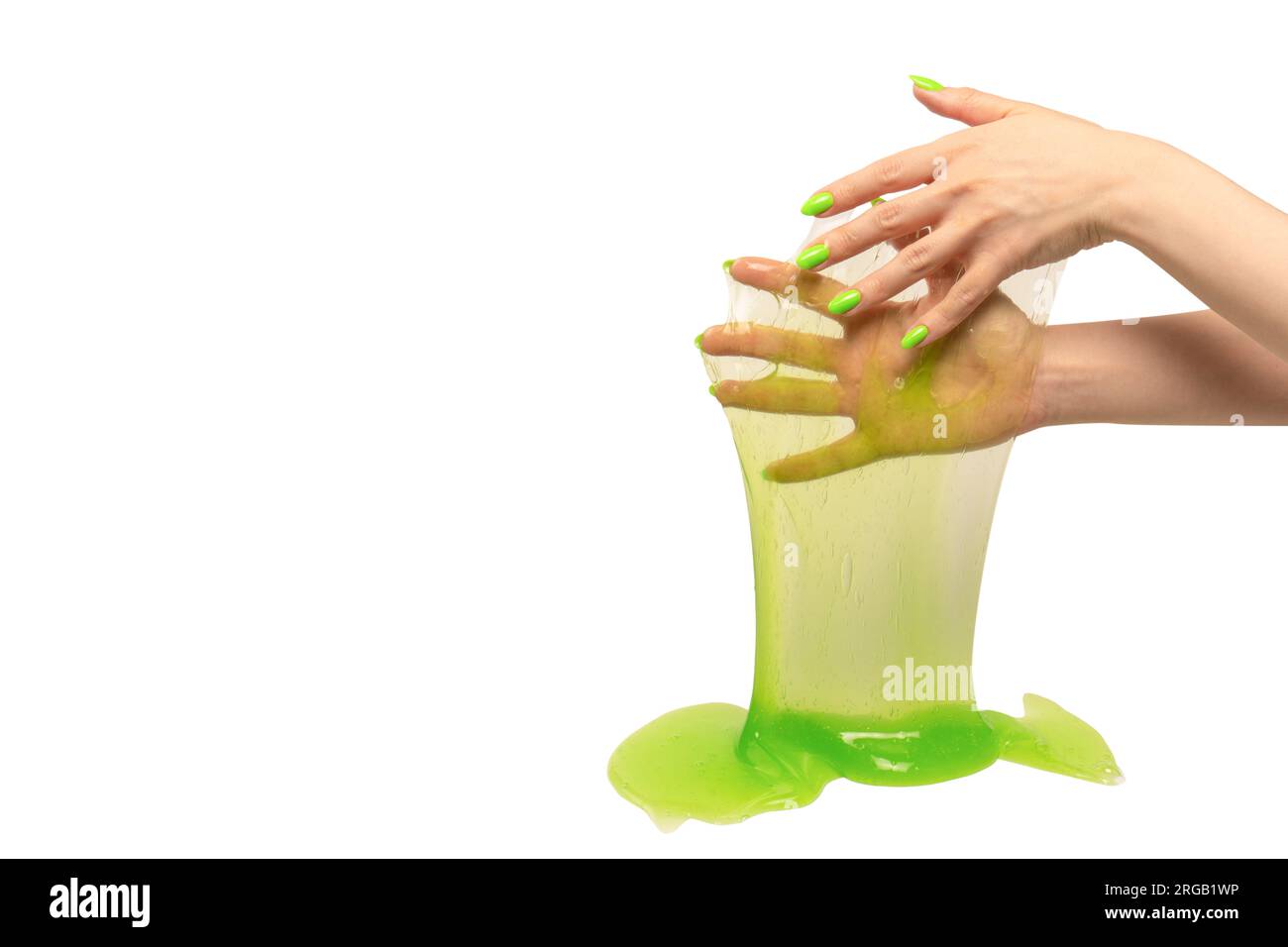 Green slime toy in woman hand with green nails isolated on a white ...