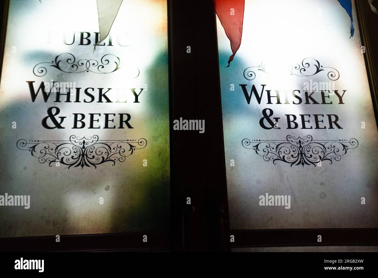 Whiskey and beer on stained glass window Stock Photo - Alamy