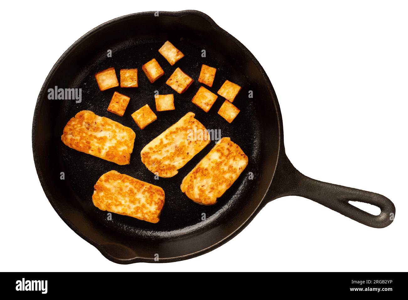 Fried slices and cubes of halloumi cheese with red chilli on cast iron ...